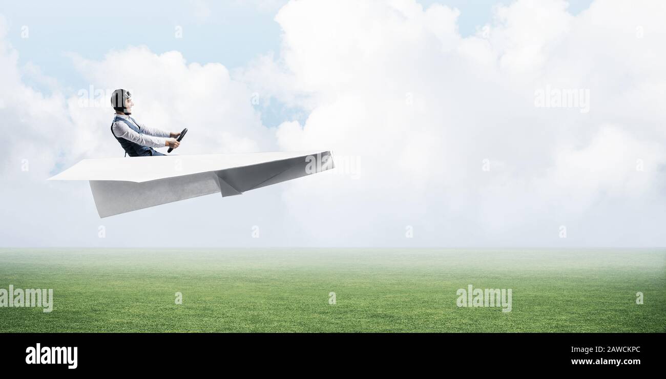 Happy aviator driving small paper plane Stock Photo - Alamy