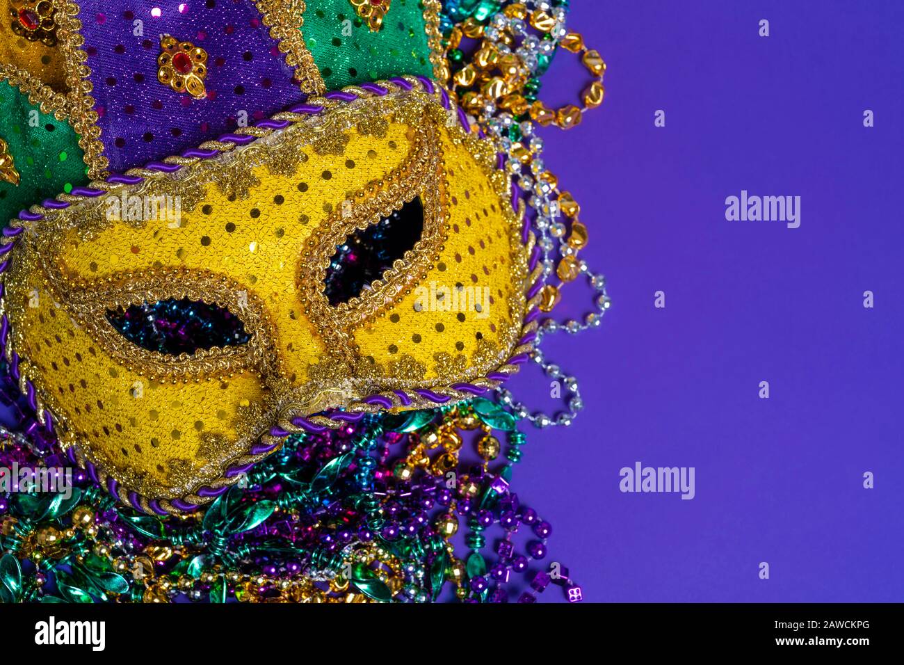 Colorful Mardi Gras mask on purple background with beads Stock Photo ...