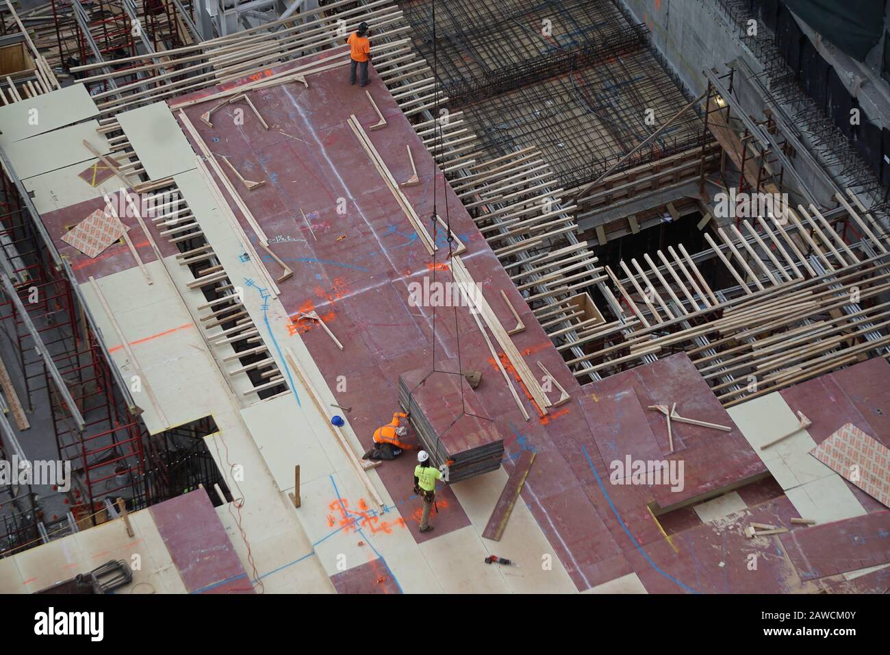 New York, New York: Aerial view of workmen guiding plywood sheets ...