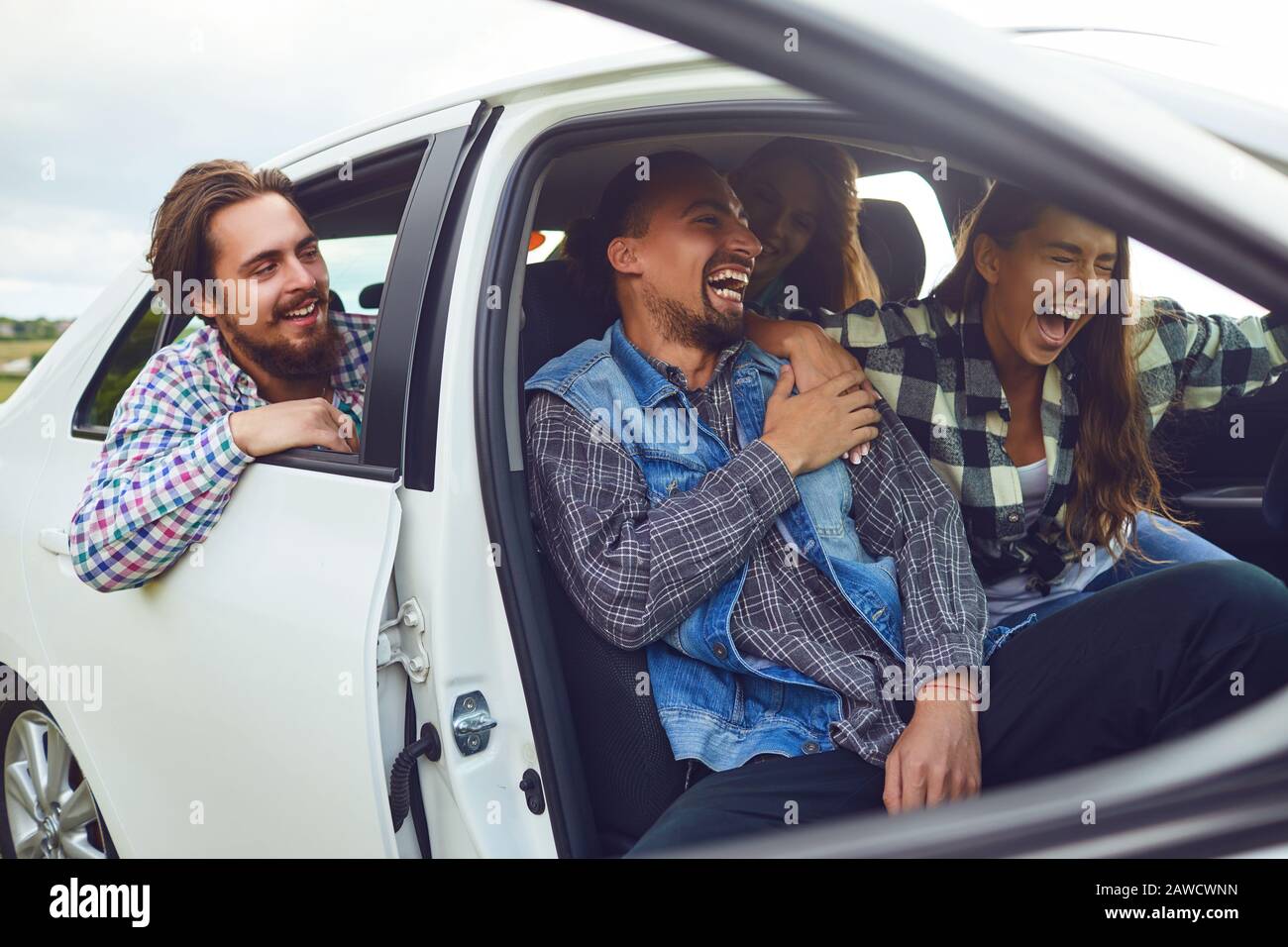 A group of happy friends are driving in a car Stock Photo - Alamy