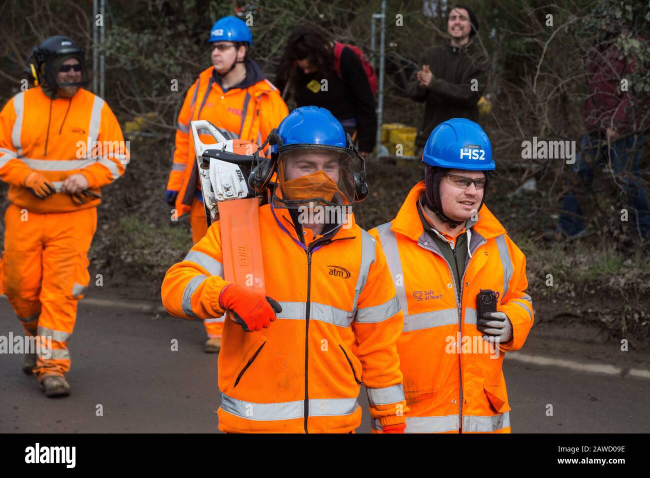 Harefield, UK. 8 February, 2020. HS2 engineers retreat with a chainsaw ...