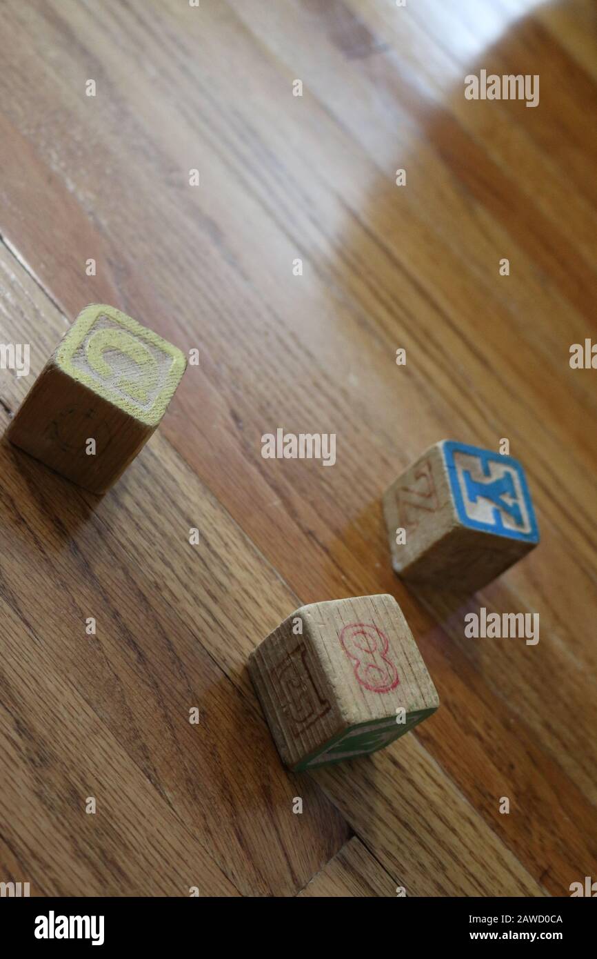 Three Old Wooden Colorful Alphabet Number Blocks on wood floor in ...