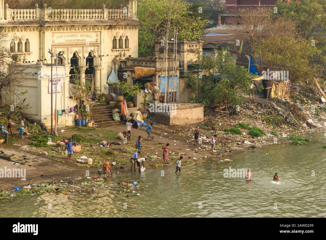 Indian people bathing in river Hooghly or Ganga at Mallick ghat. View ...