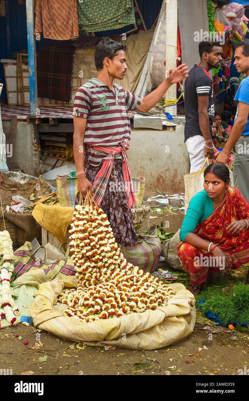 Indian trader with flower garland on Flower market at Mallick Ghat in ...