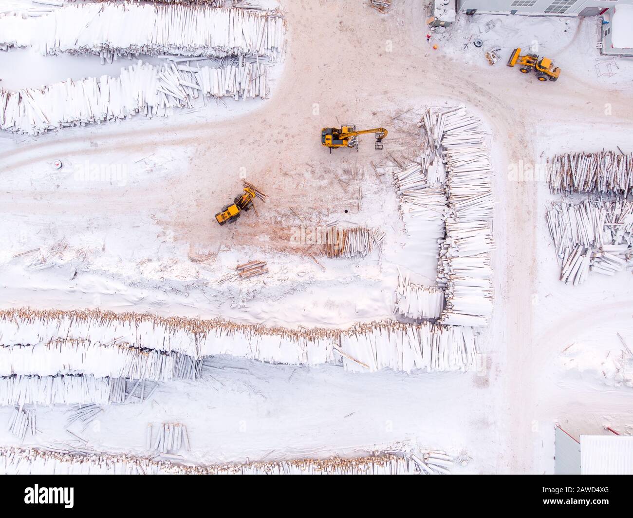 Industrial photo, storage of wooden logs under the snow at a sawmill ...