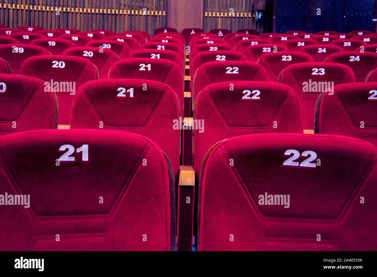 Red colored chairs at empty movie theater Stock Photo - Alamy