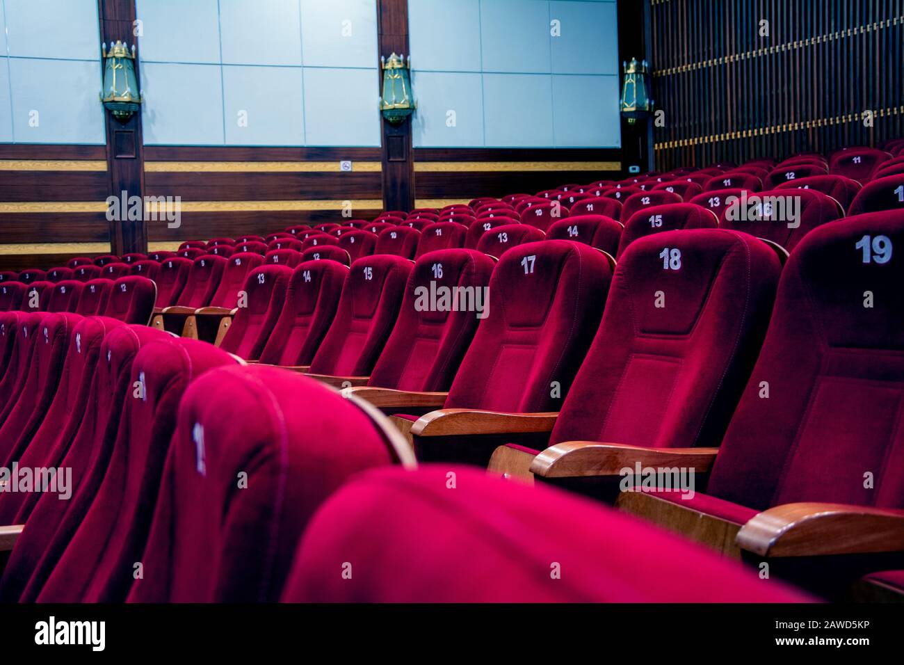 Red colored chairs at empty movie theater Stock Photo - Alamy