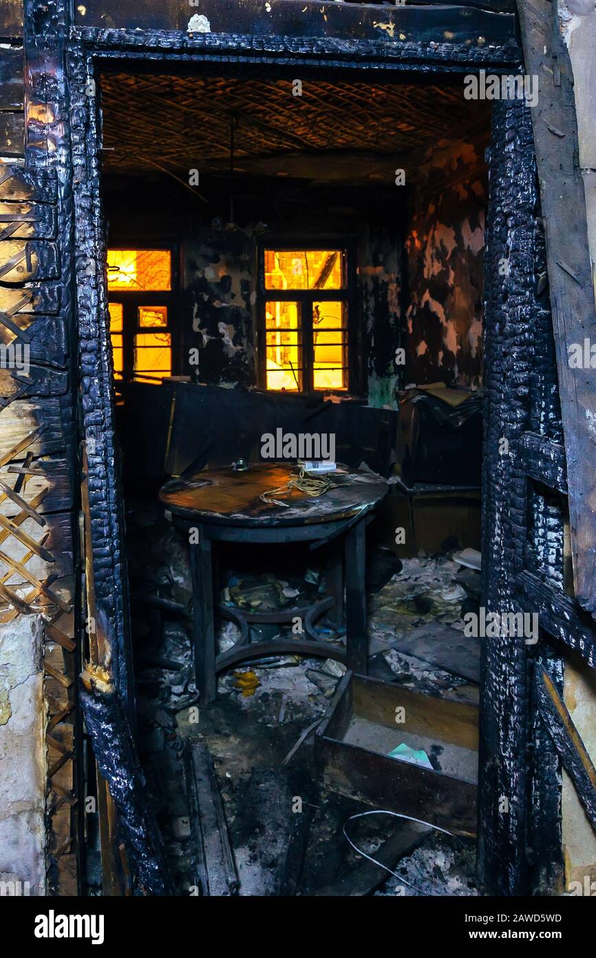 Burnt house interior. Burned furniture, charred walls and ceiling in ...