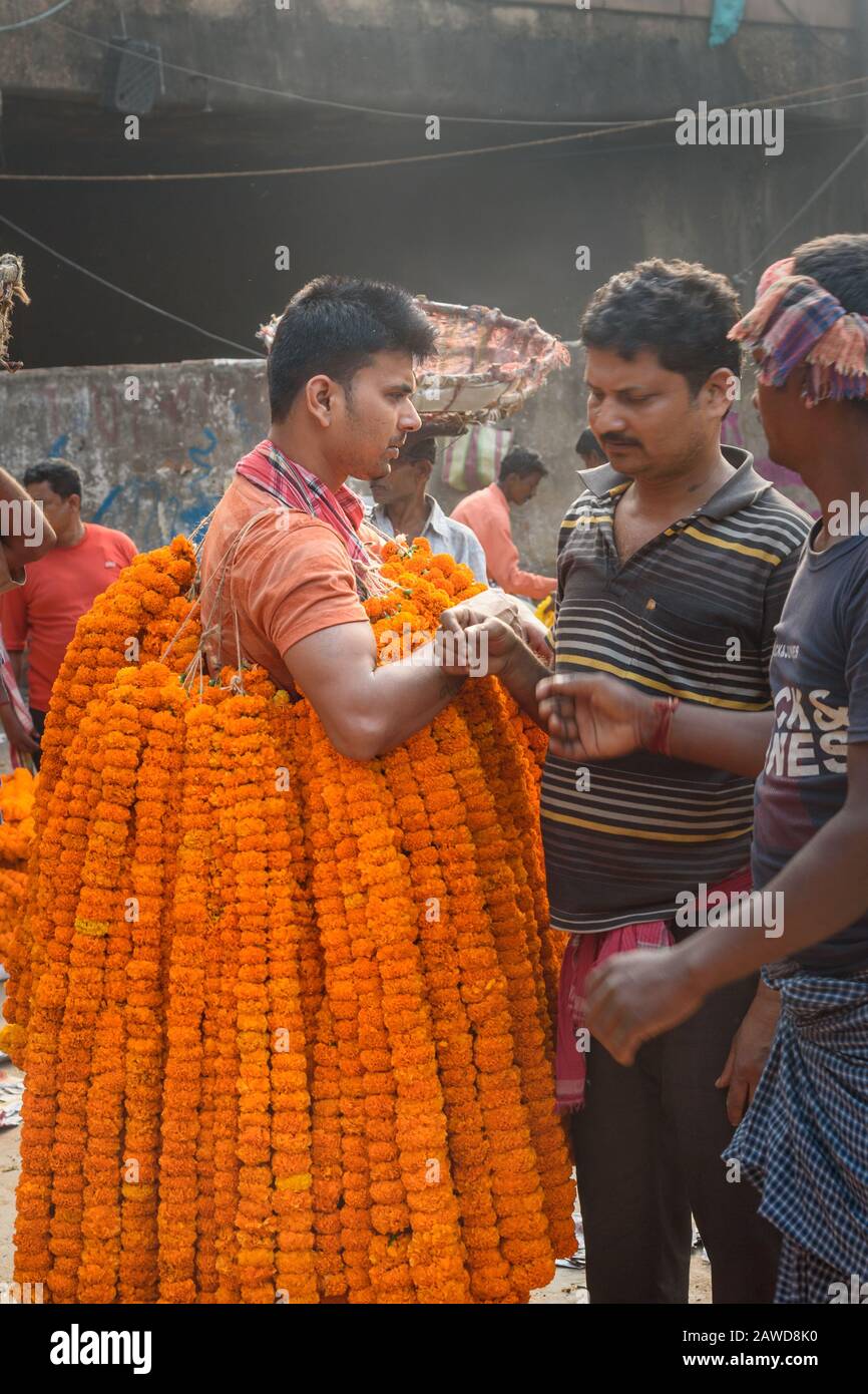 Indian trader with flower garland on Flower market at Mallick Ghat in ...