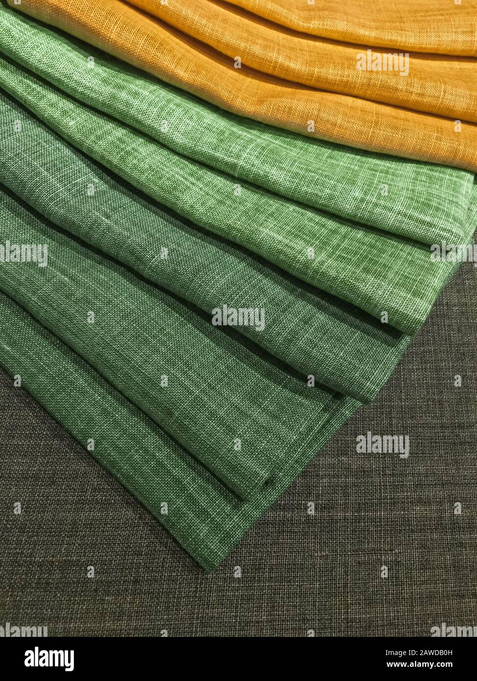 Choice of green and yellow textiles in a fabric store Stock Photo - Alamy