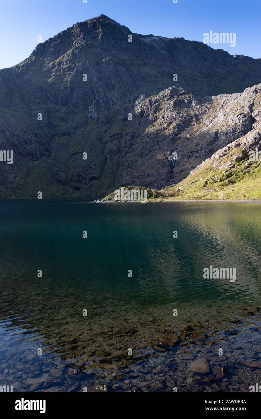 Beautiful sunlight over a clear mountain lake Stock Photo - Alamy