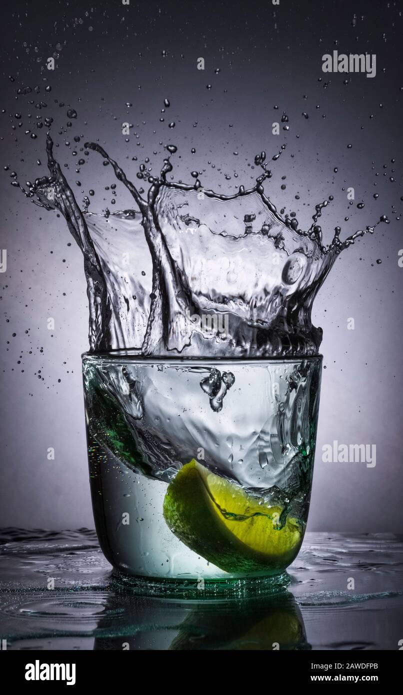 Shot of a splash of an lime dropped in a glass of soda water Stock ...