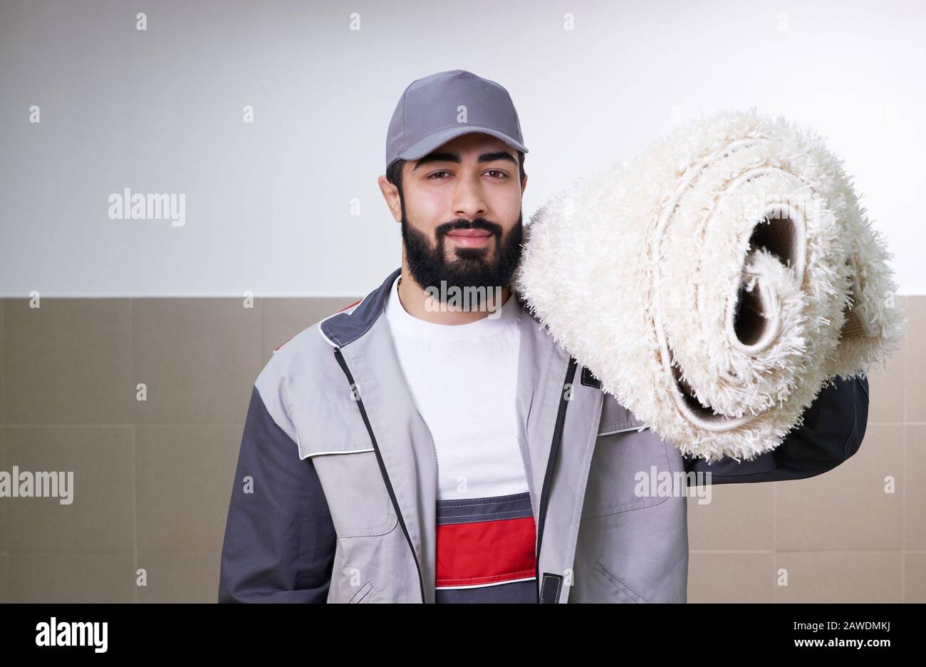 Man with a roll of carpet Stock Photo - Alamy