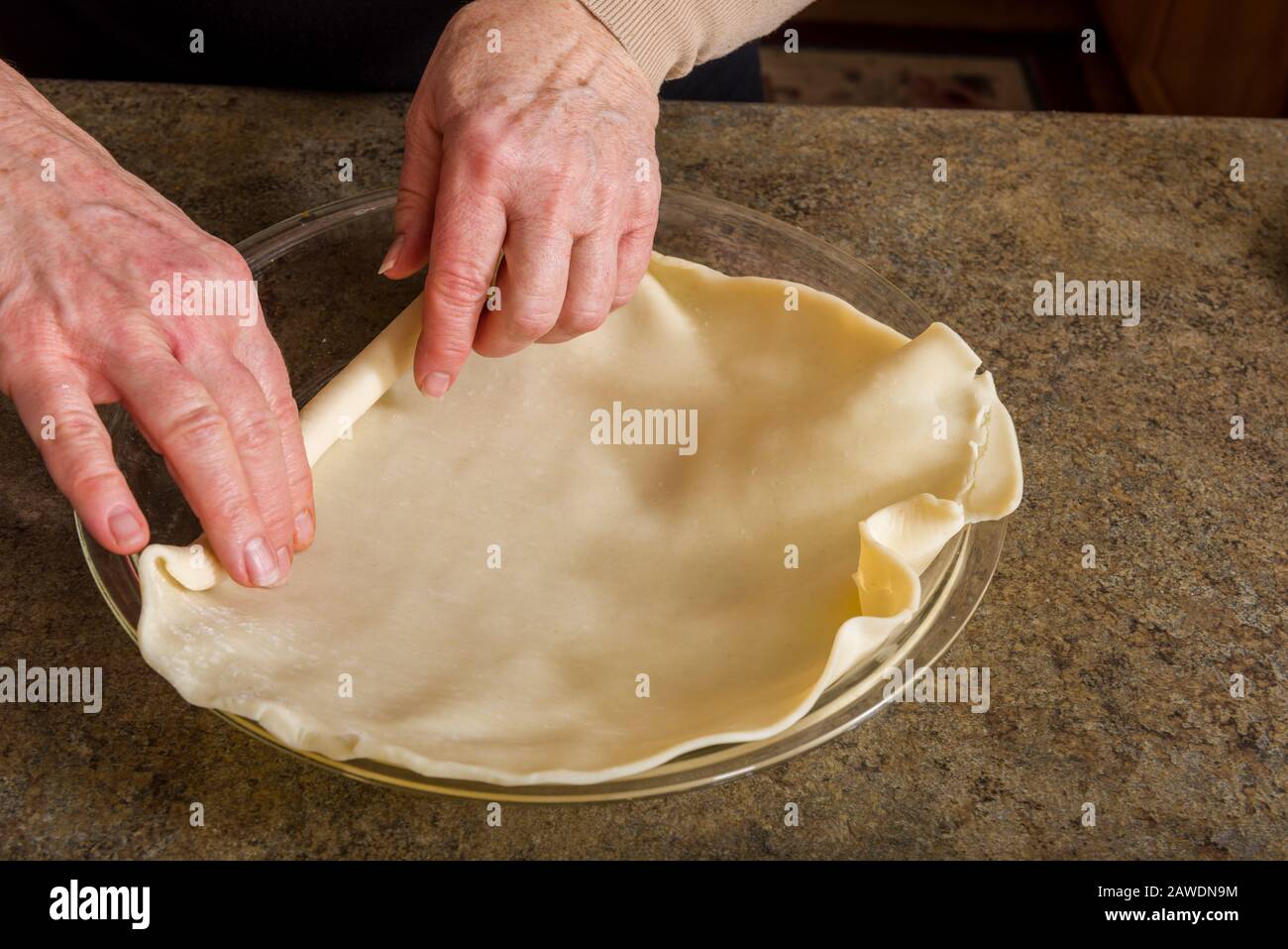 Pie crust being pulled apart and put into a glass bowl Stock Photo - Alamy