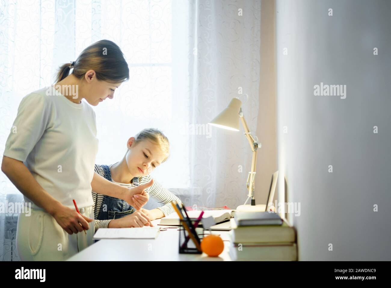 Mother and daughter doing homework together Stock Photo - Alamy