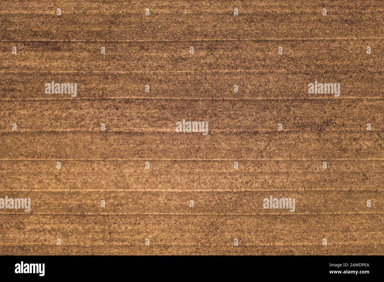 Textured ground surface with parallel lines from cultivator, top view ...