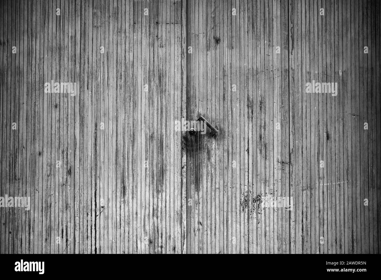 Spoiled and dirty metallic background, detail of a steel door down and ...
