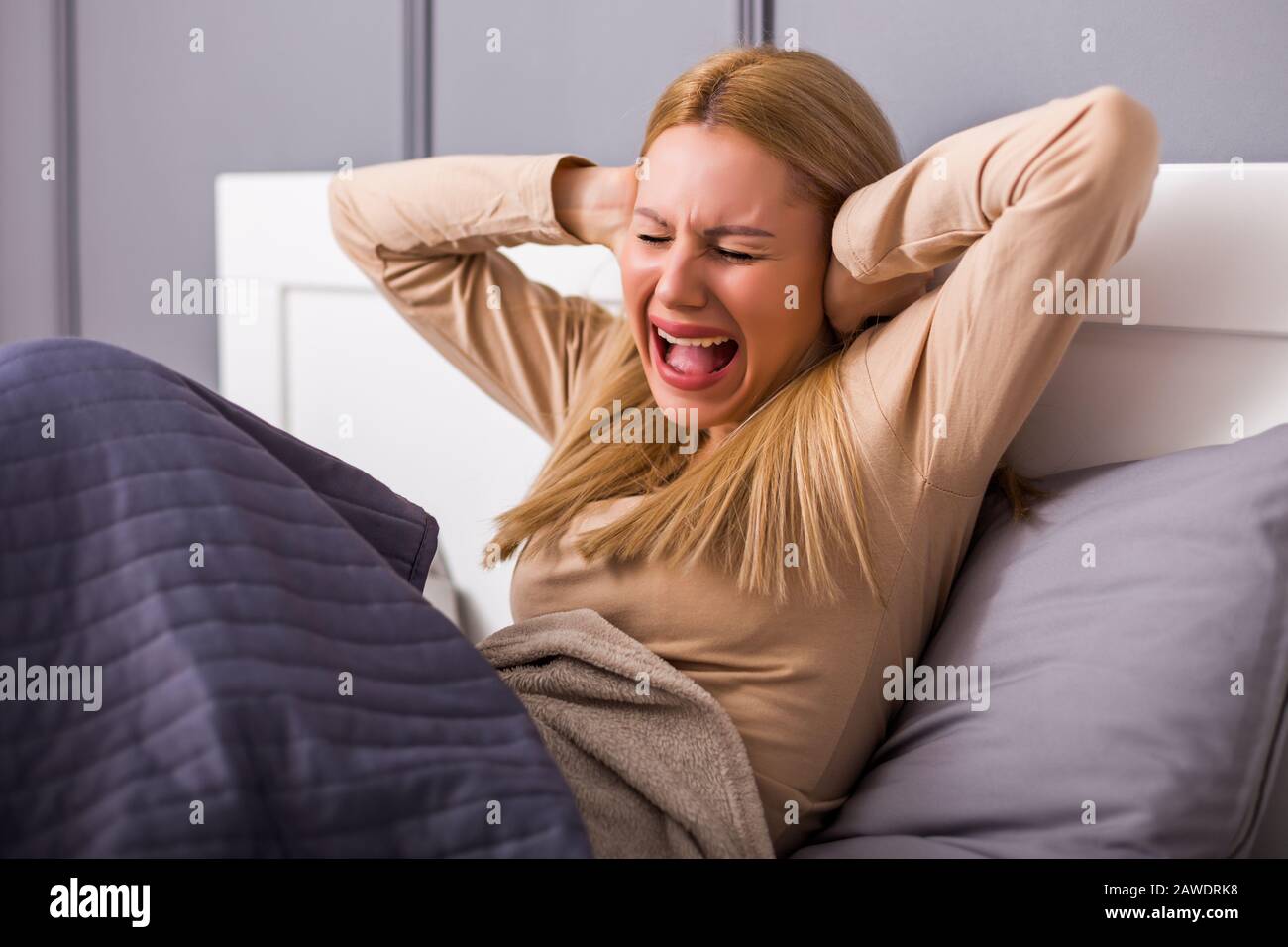 Angry woman disturbed with a noise having problems with sleeping Stock ...