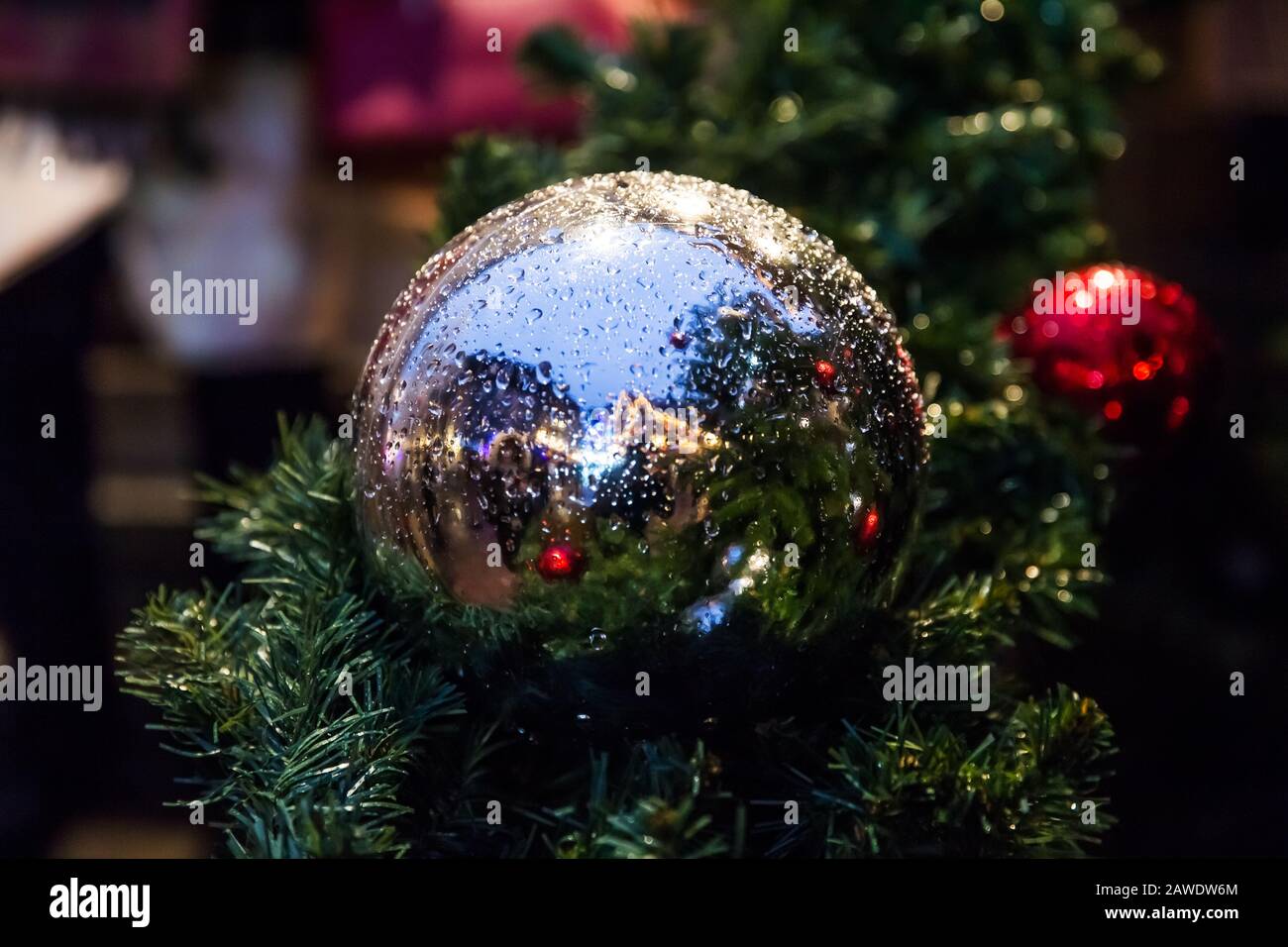 Closeup of red bauble hanging from a decorated Christmas tree Stock ...