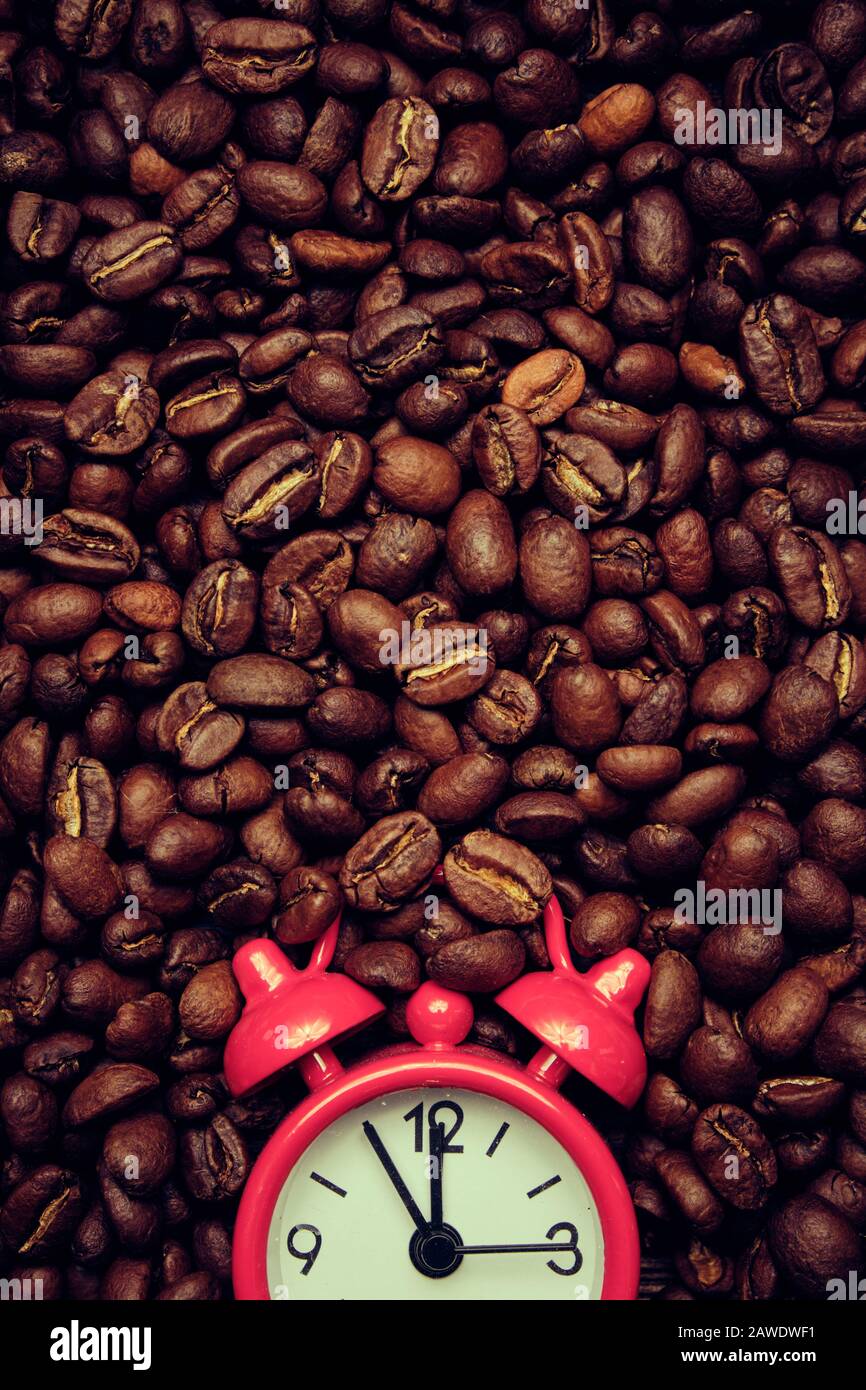 The concept of roasting coffee beans. Red clock. Close up Stock Photo ...