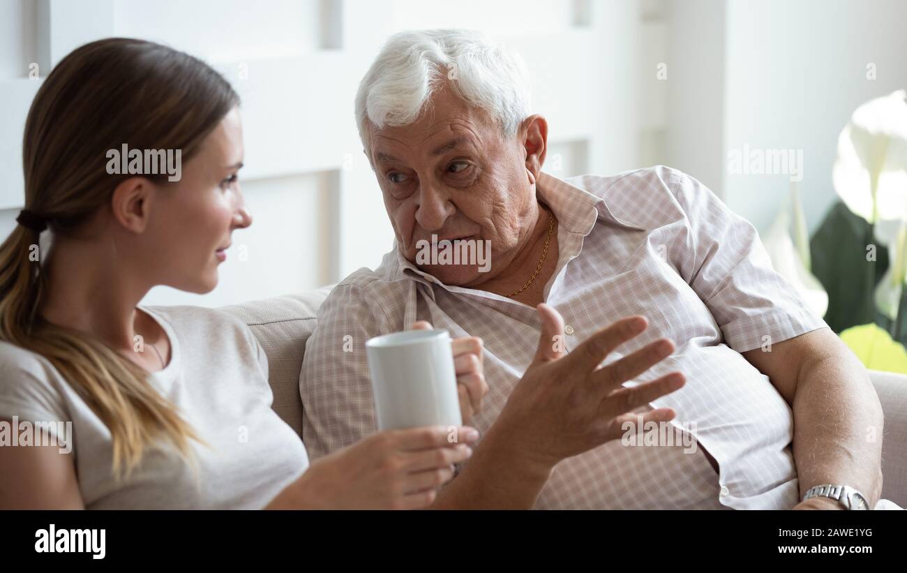 Mature father and adult daughter talking drinking tea Stock Photo - Alamy