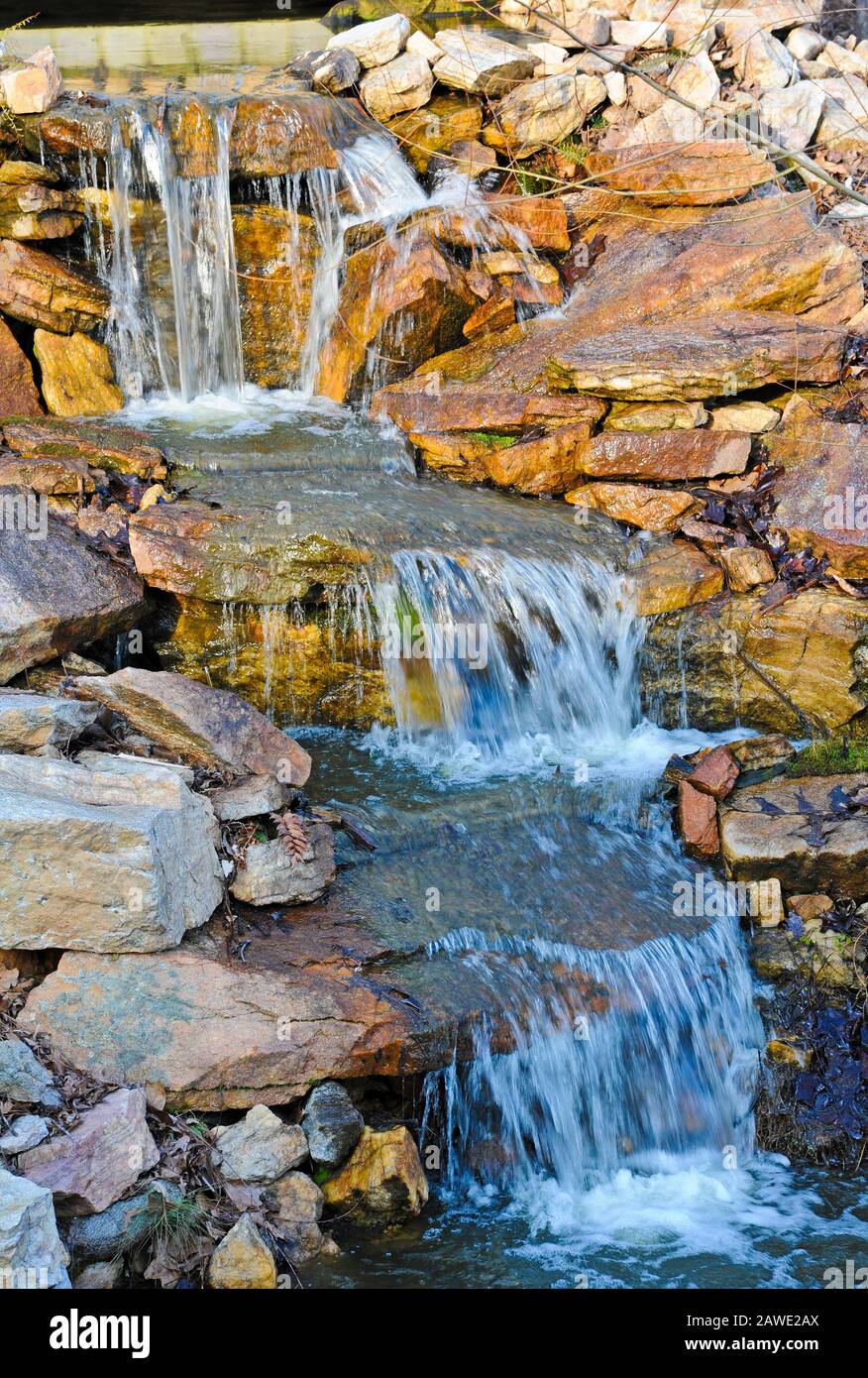 Water Cascading over Stone Waterfall Feature Stock Photo - Alamy