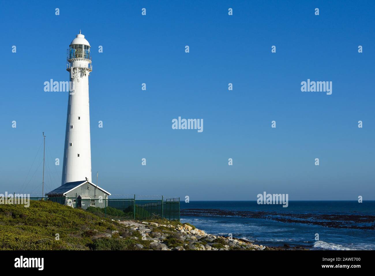 Tall White Lighthouse Overlooking The Ocean Stock Photo - Alamy