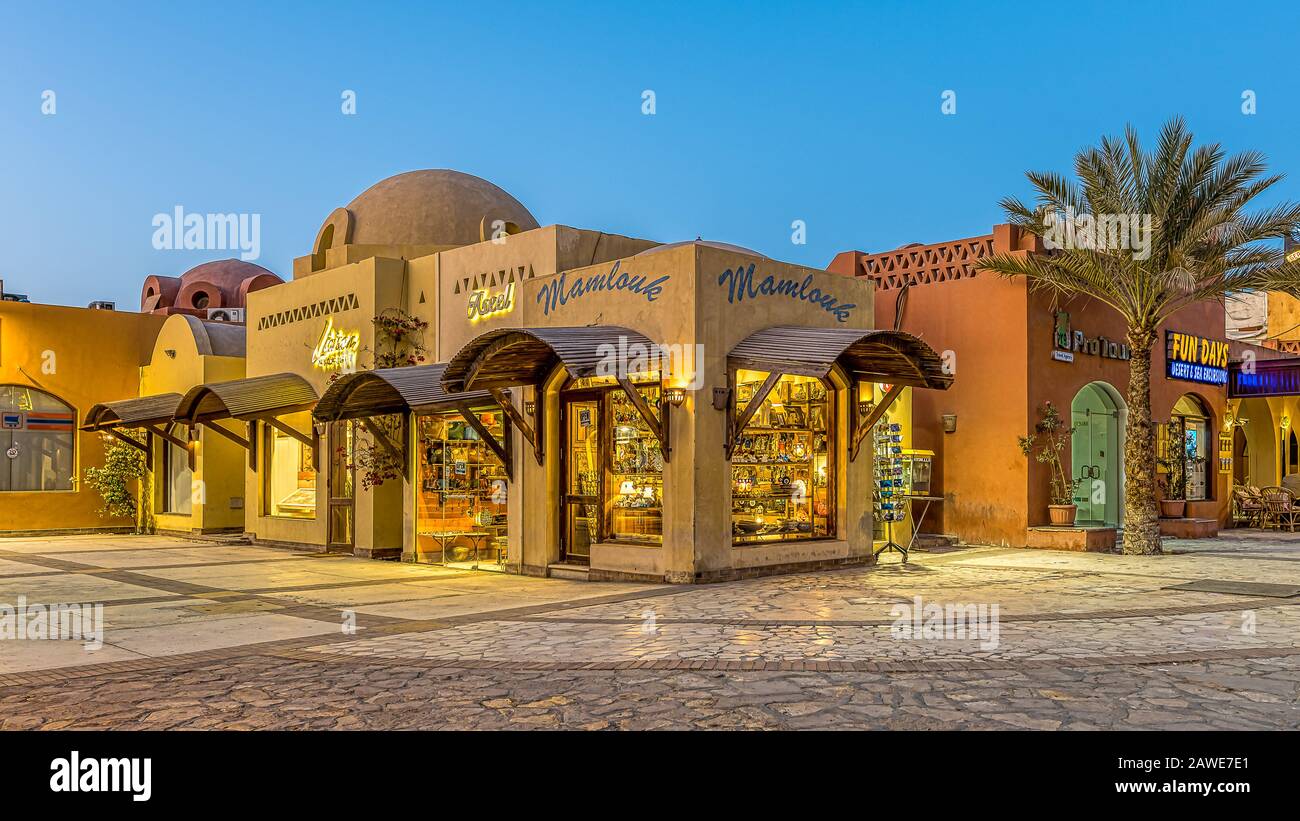 illuminated shops and buildings at an egyptian square in the twilight ...