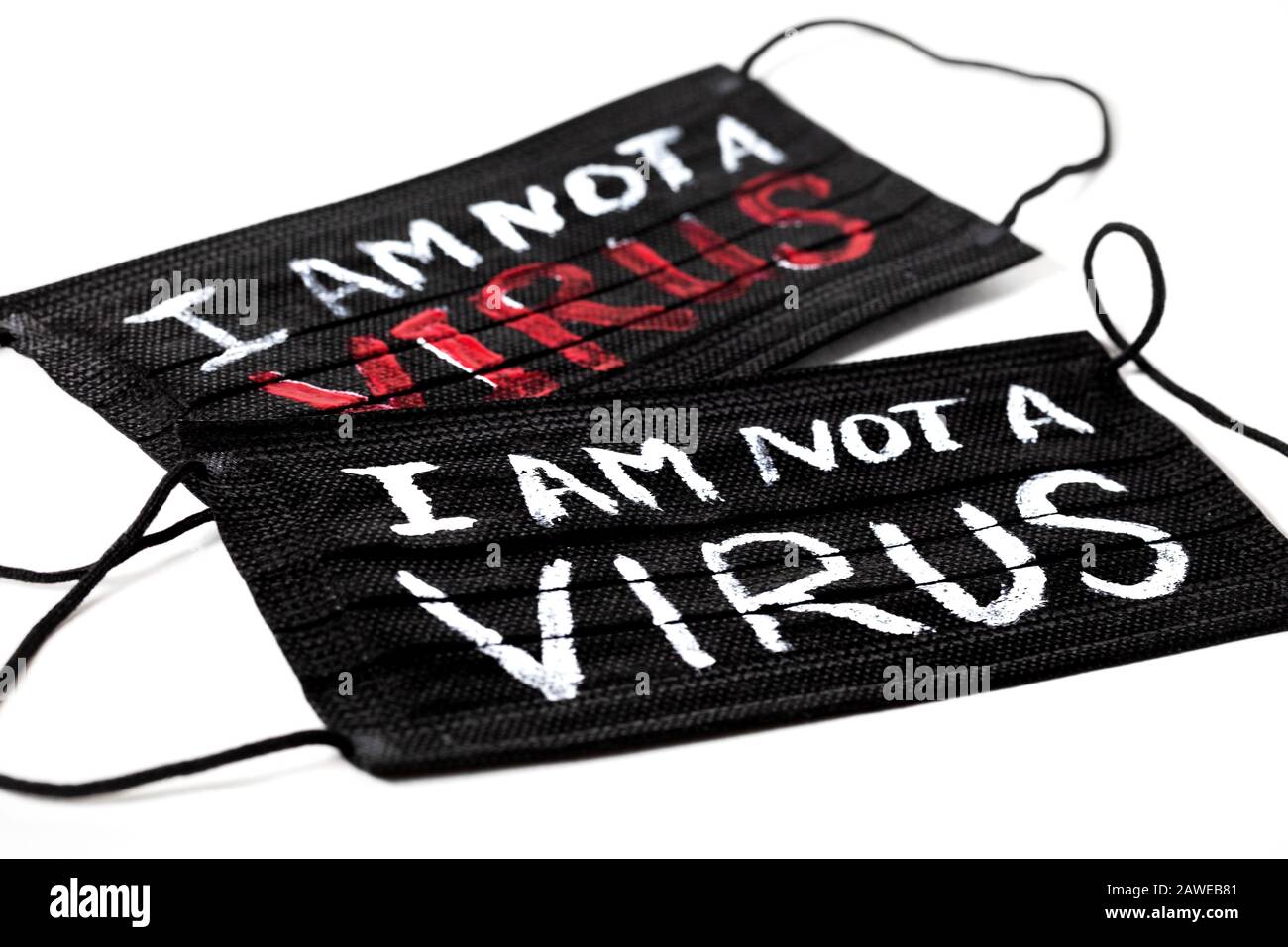 Black medical masks with the inscription "I am not a virus" on white ...