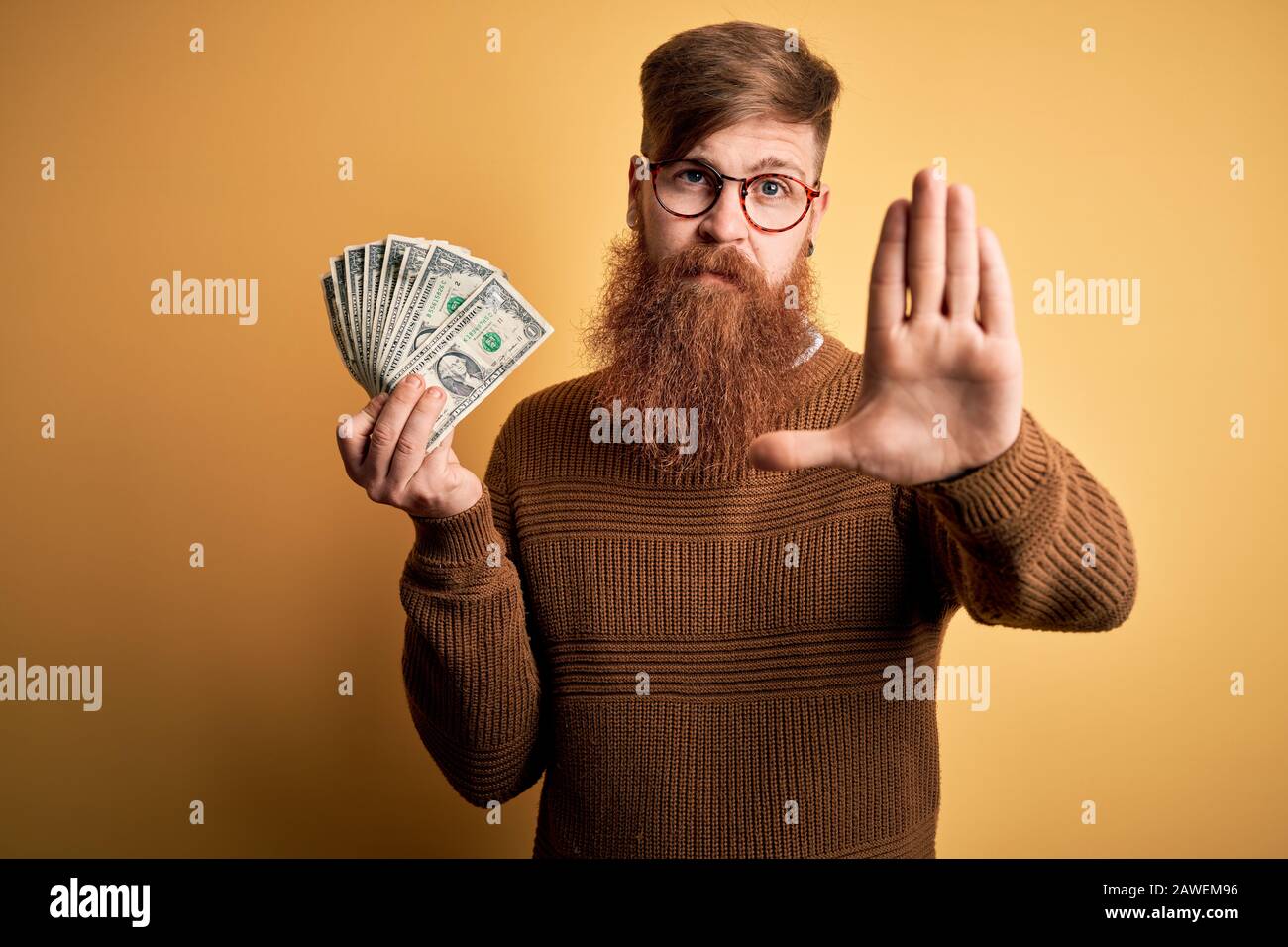 Redhead Irish man with beard holding a bunch of 1 dolla banknotes over ...
