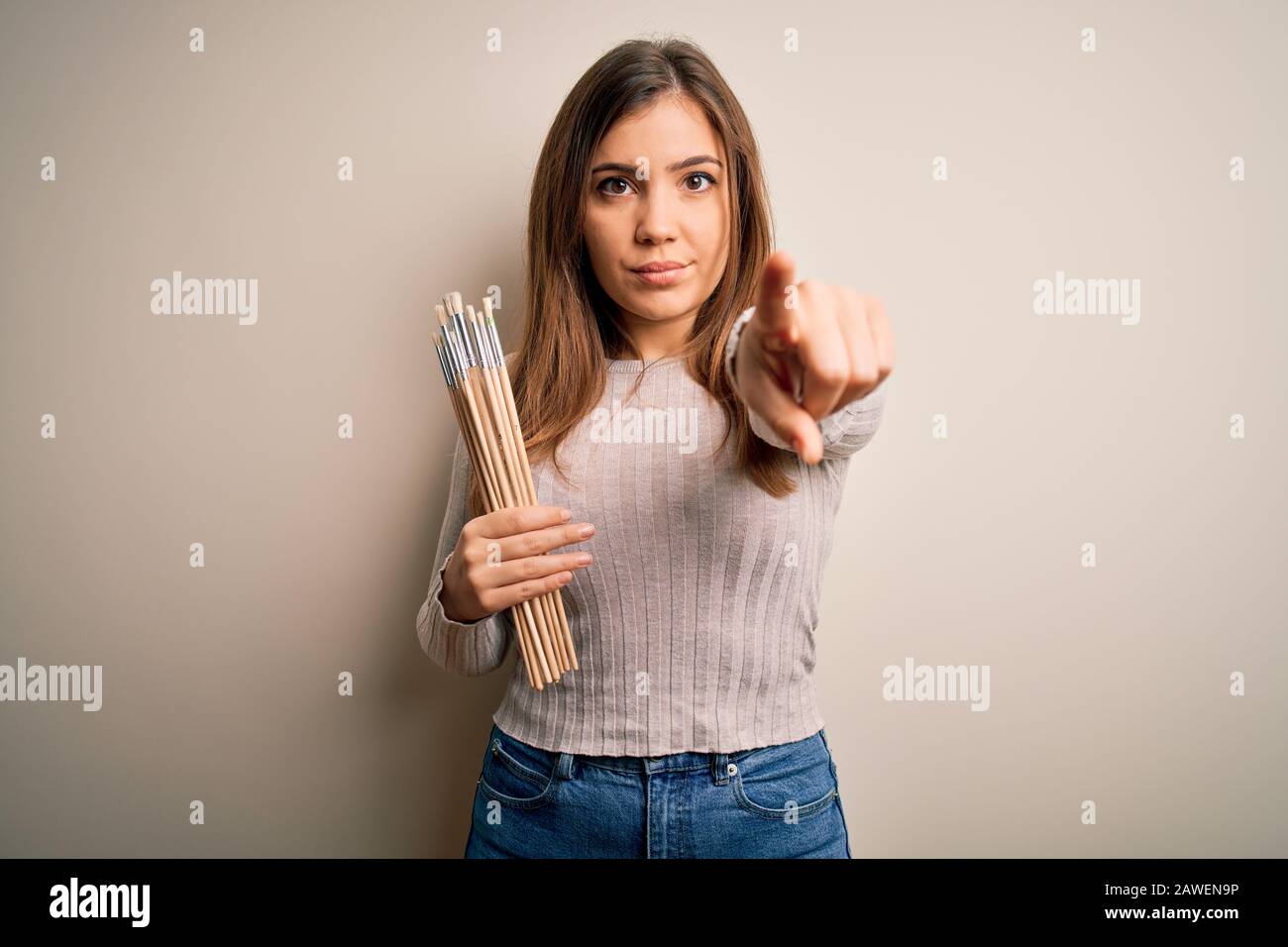 Young painter artist woman painting using paintbrush over isolated ...
