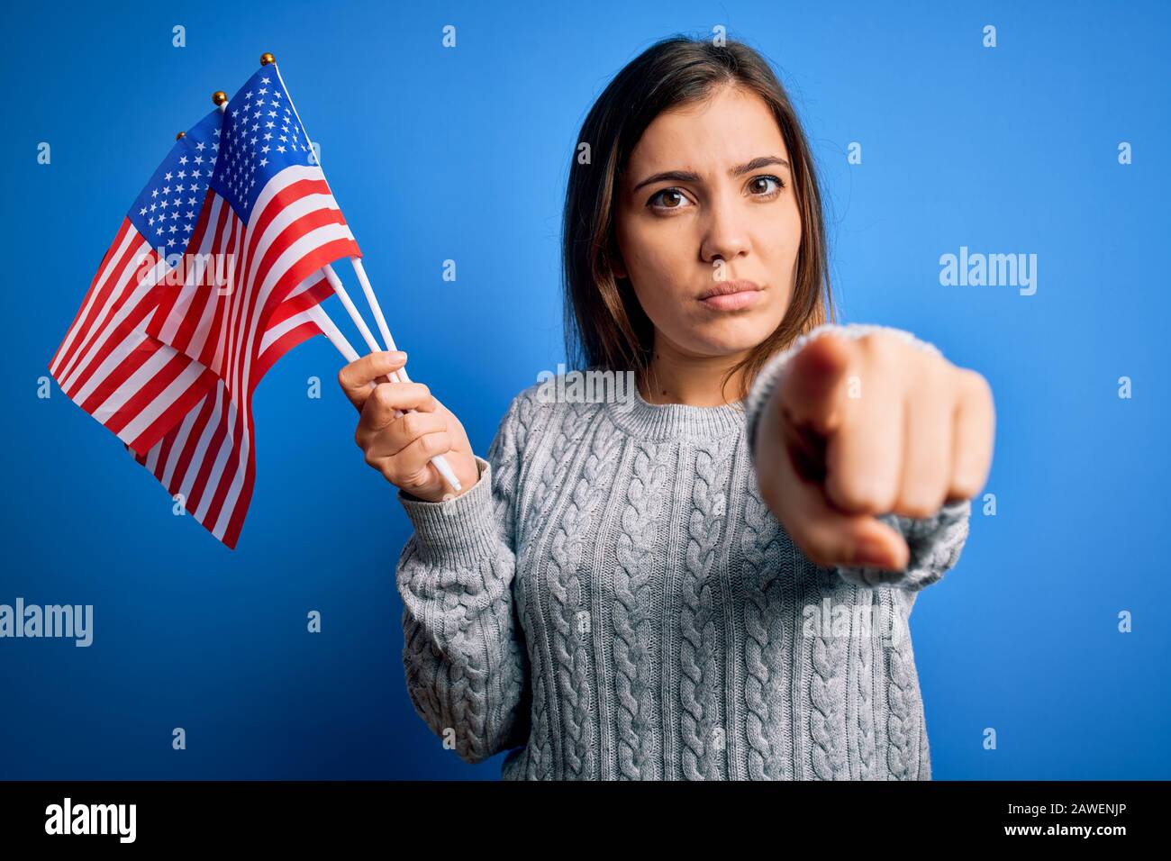 Young patriotic woman holding usa flag on independence day 4th of july ...