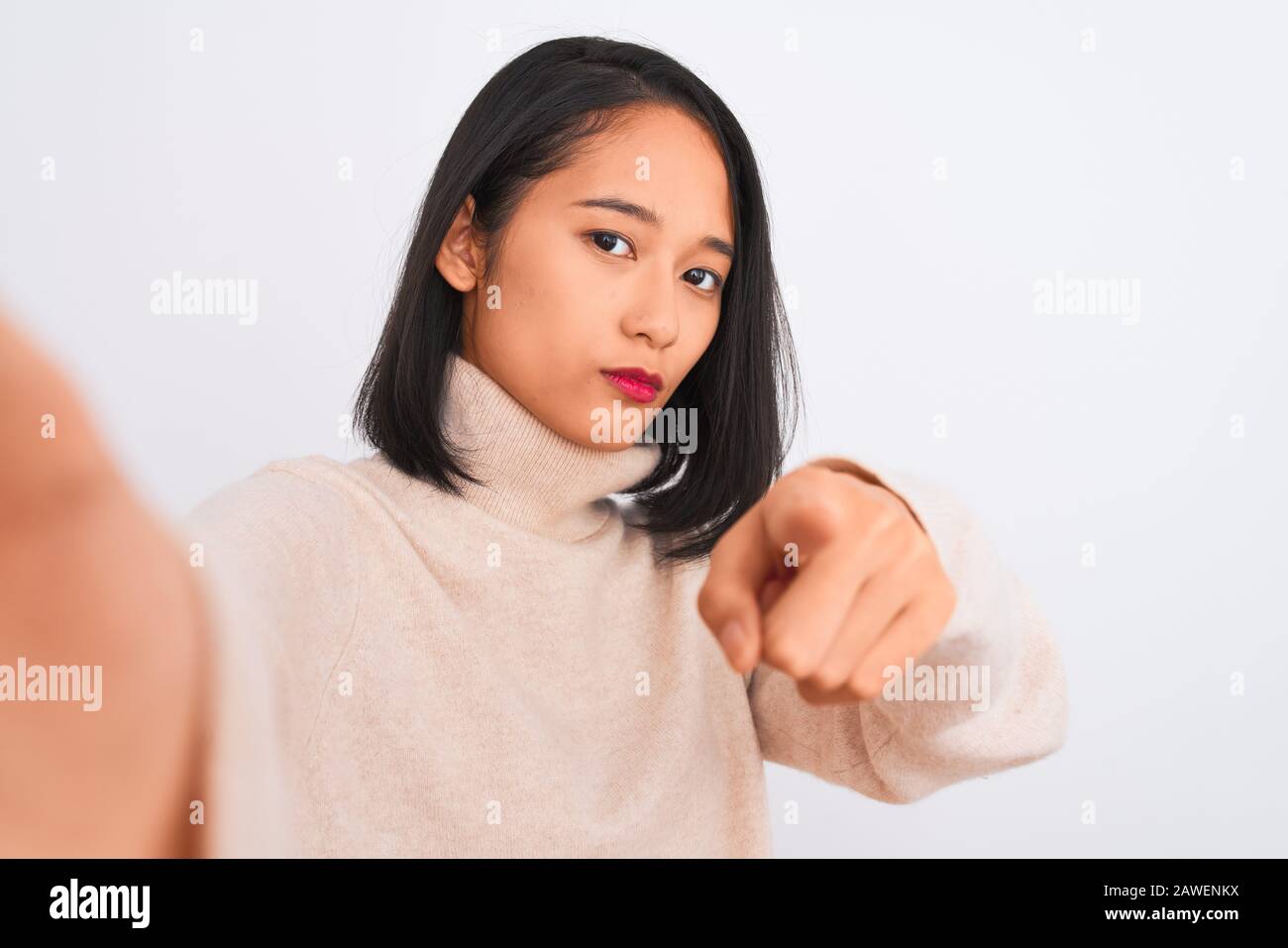Young chinese woman wearing turtleneck sweater make selfie over ...
