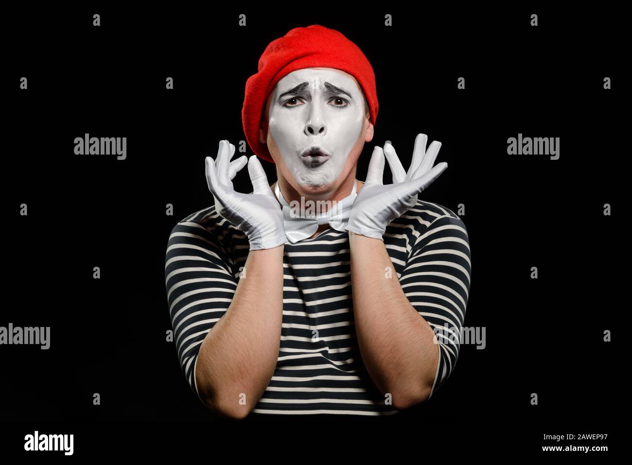 Worried male mime on black. Waist up portrait of male mime Stock Photo ...