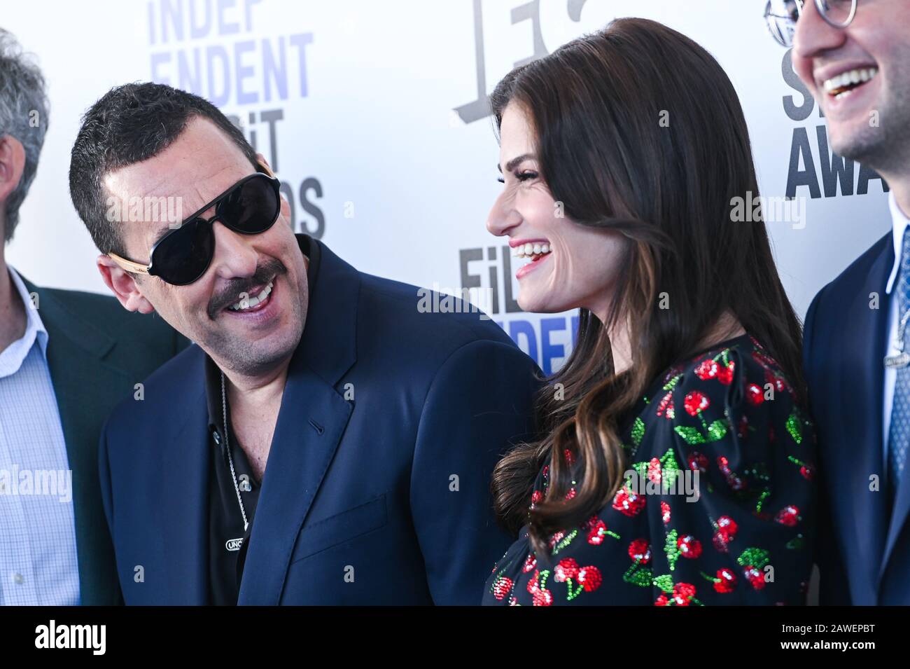 Adam Sandler and Idina Menzel walking on the red carpet at the 35th ...