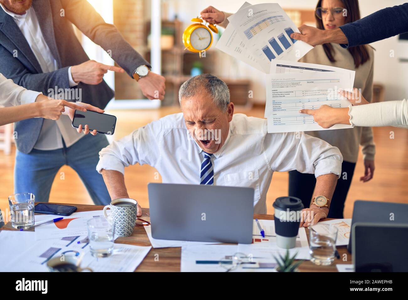 Group of business workers working together. Partners stressing one of ...