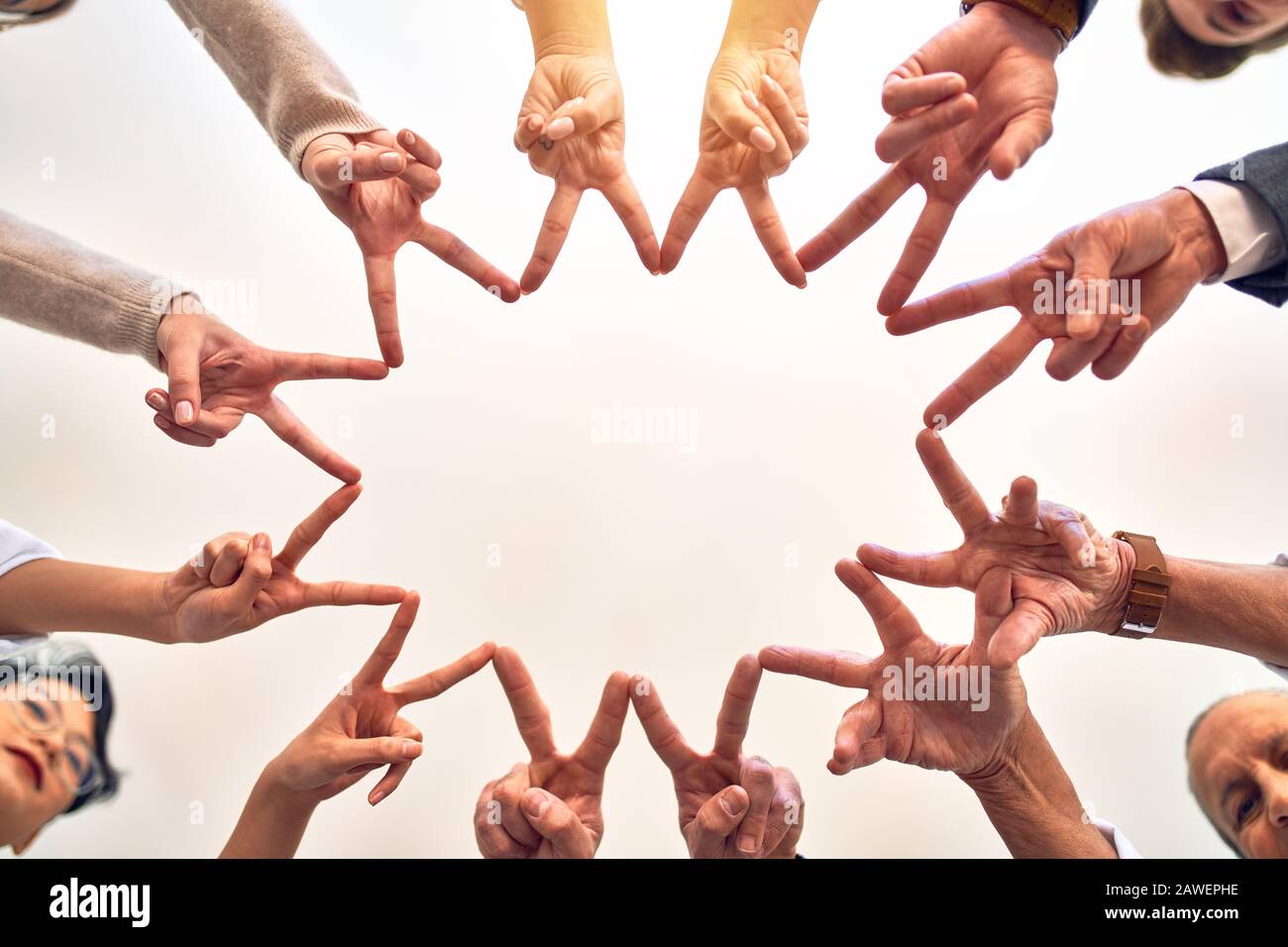 Group of business workers standing doing symbol with fingers together ...
