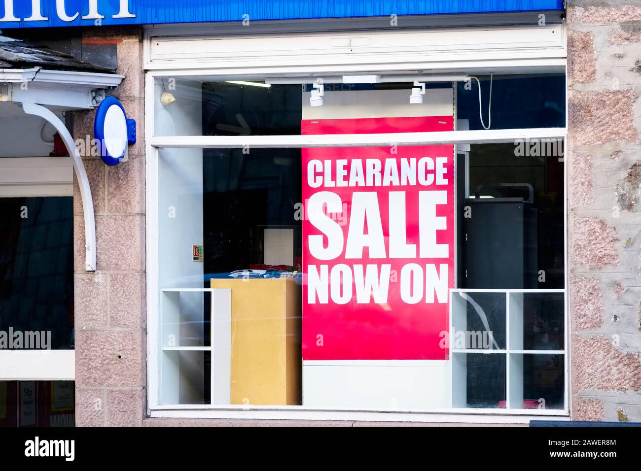 Clearance sale now on sign in shop mall window Stock Photo - Alamy