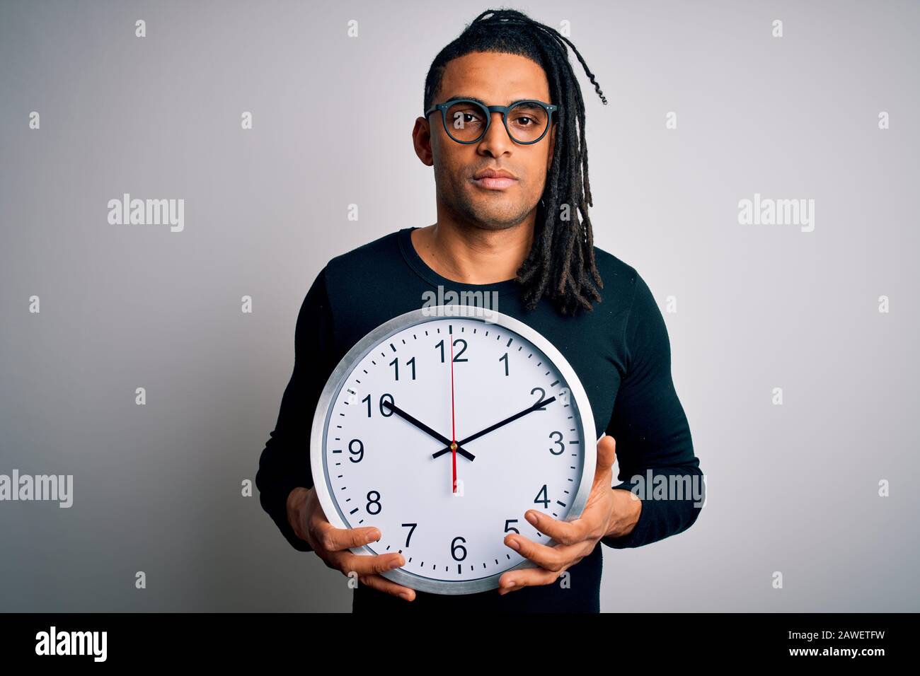 Young african american afro man doing countdown holding bic clock over ...