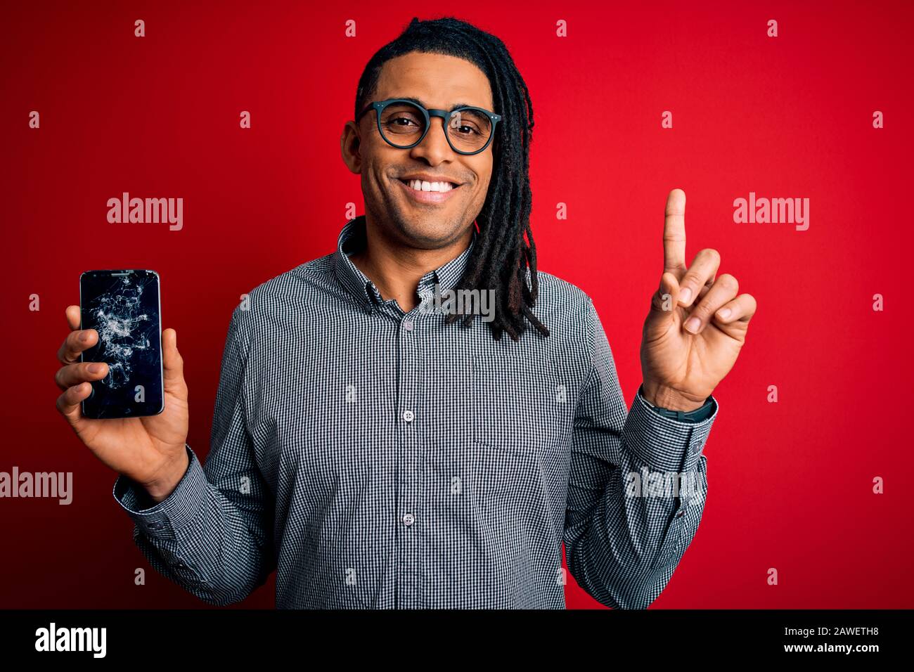 Young african american afro man holding broken smartphone showing ...