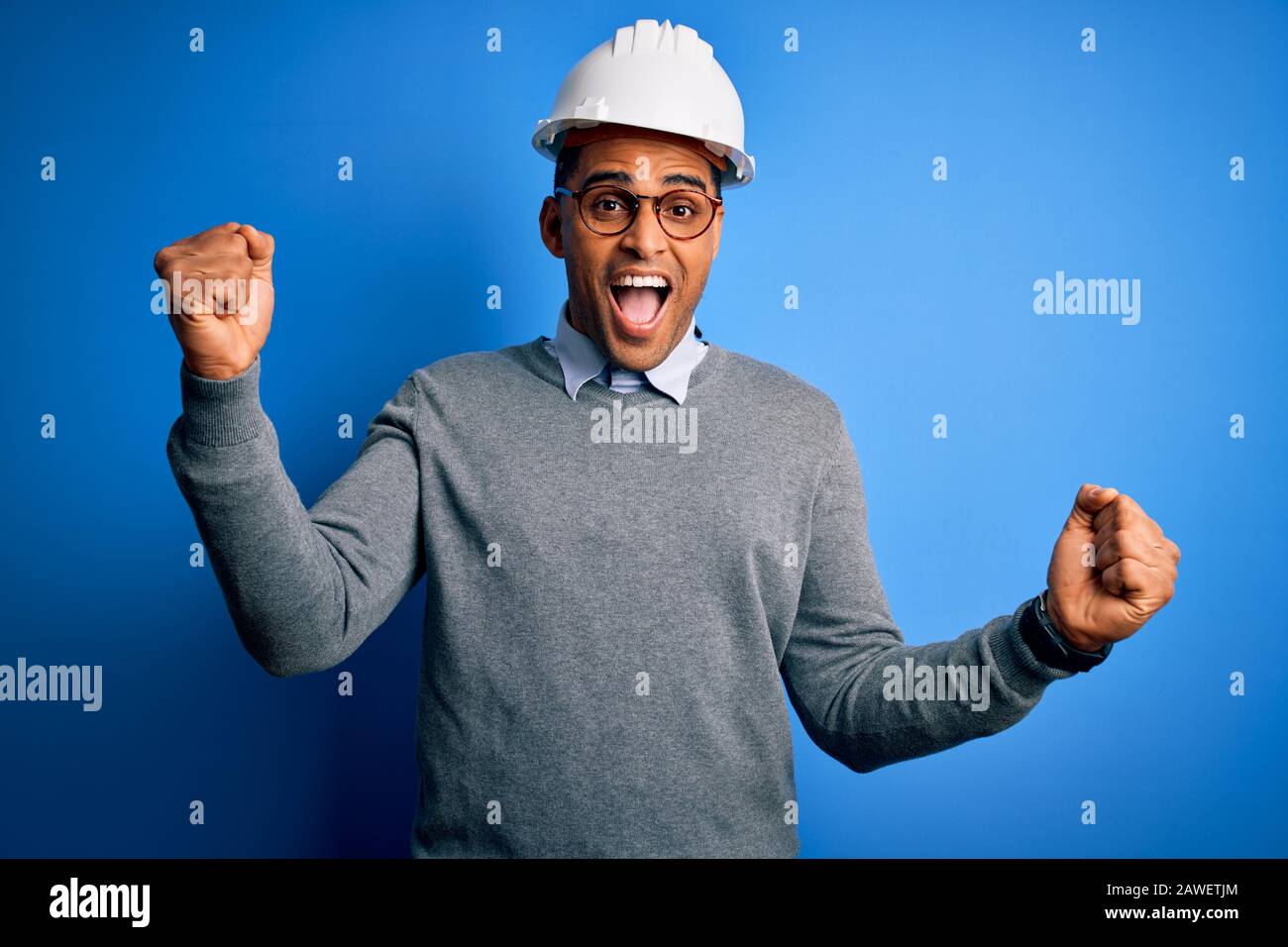 Young handsome african american engineer man with dreadlocks wearing ...