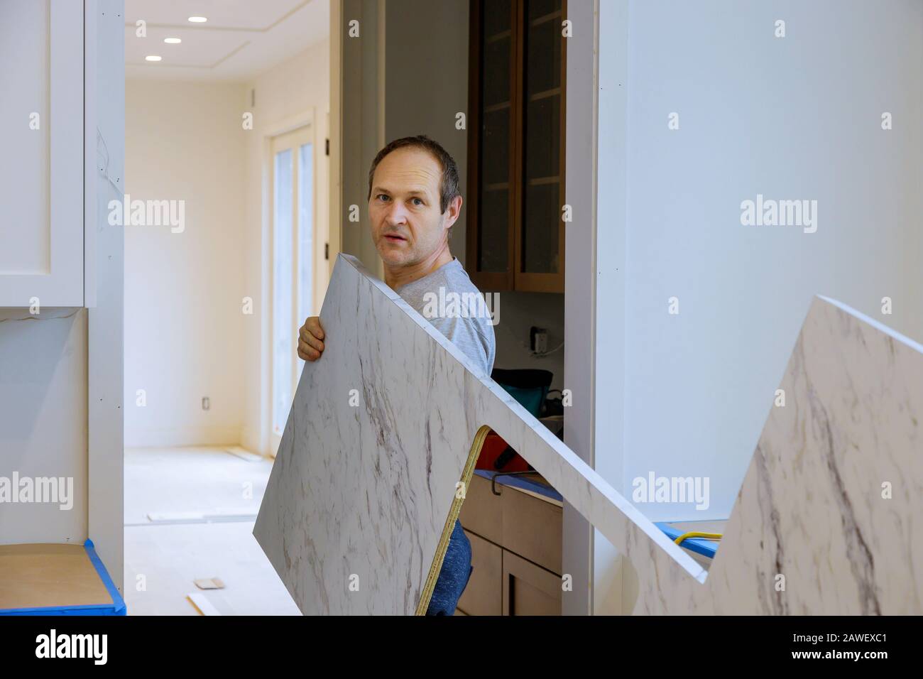 Installing laminate kitchen counter top a kitchen remodel Stock Photo ...