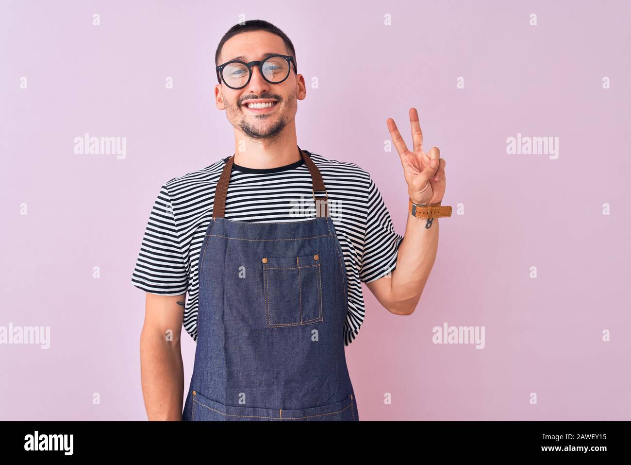 Young handsome man wearing employee apron over isolated background ...