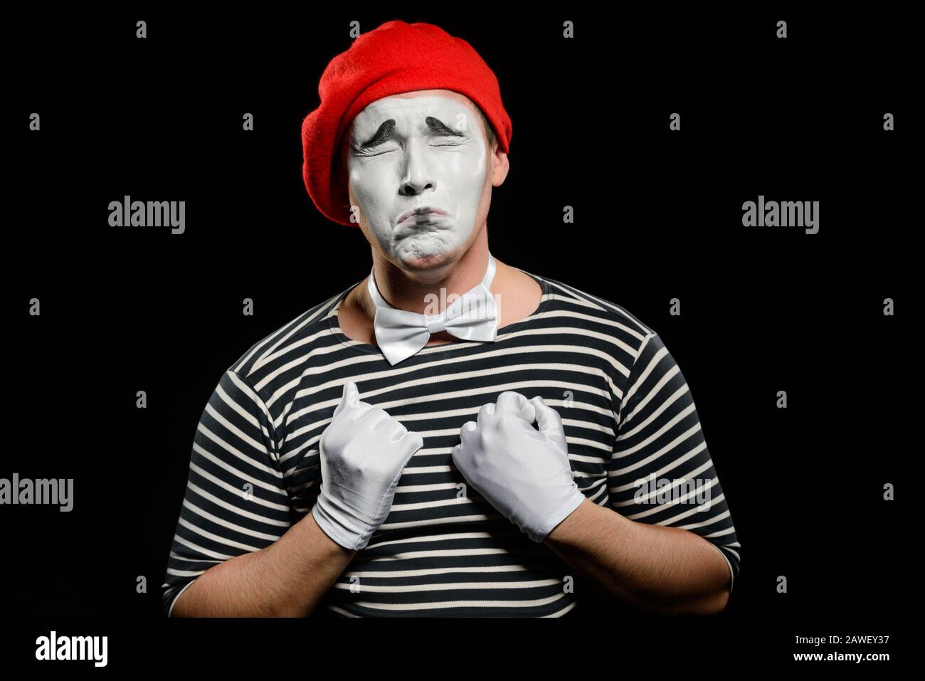 Crying male mime on black background. Waist up portrait Stock Photo - Alamy