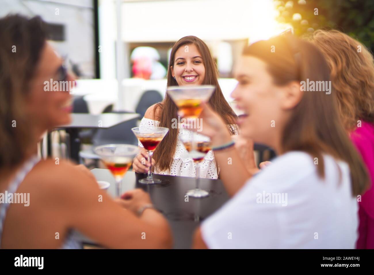 Beautiful group of women sitting at terrace of restaurant drinking ...