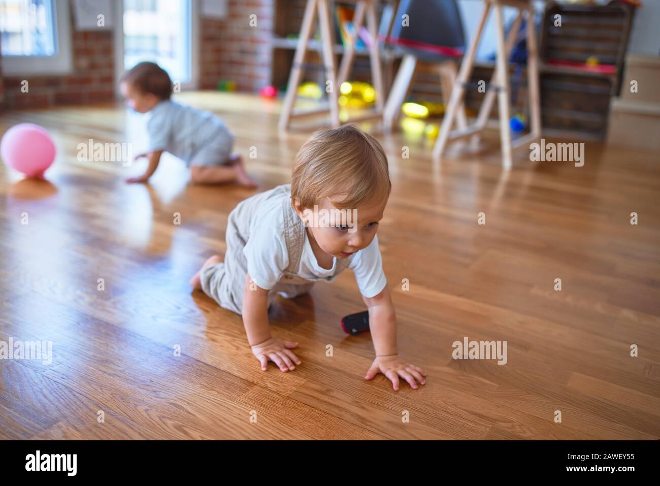Beautiful toddlers playing around lots of toys at kindergarten Stock ...
