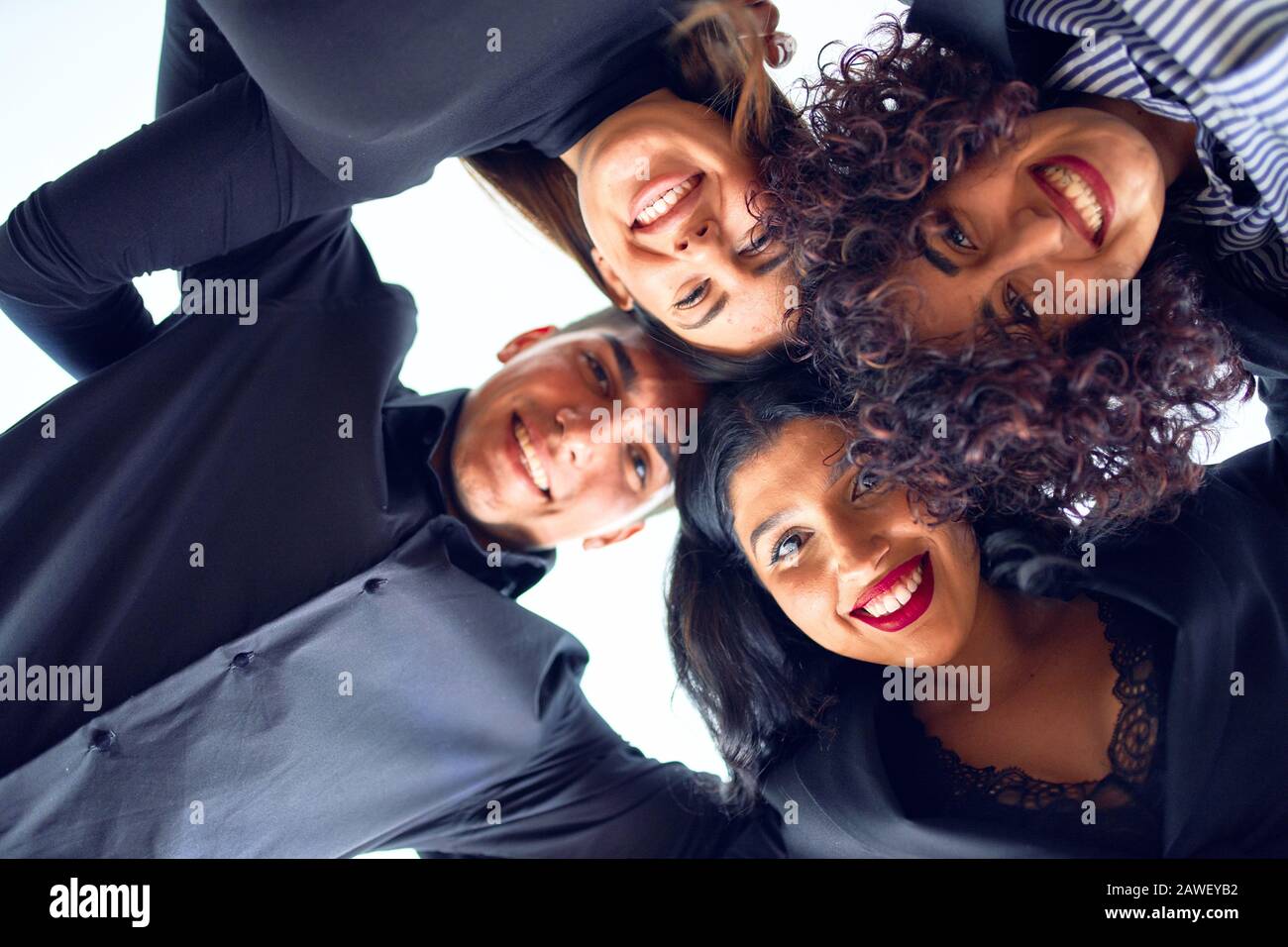 Group of business workers smiling happy. Standing with heads together ...