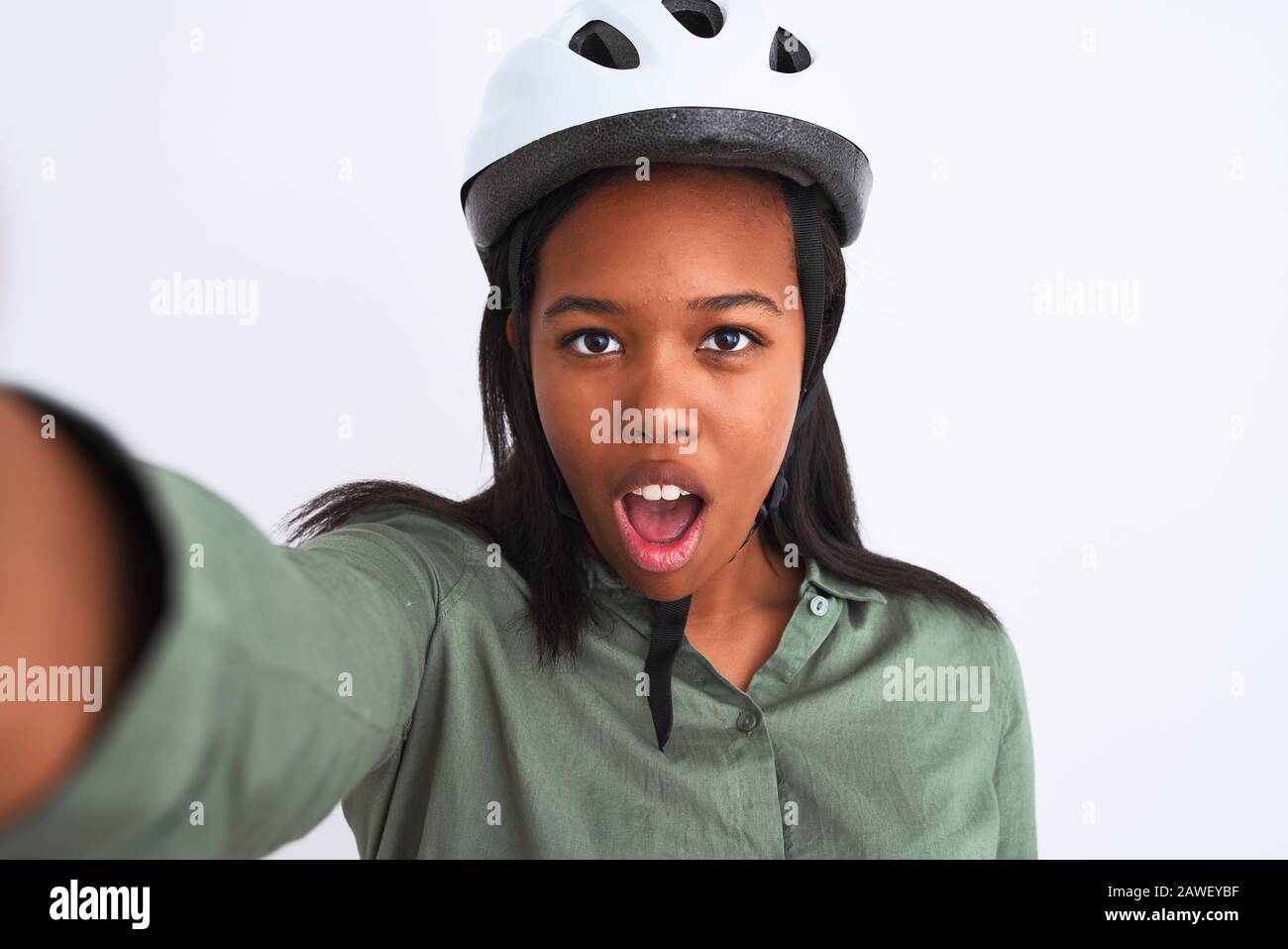 Young african american woman wearing bike helmet taking a selfie over ...