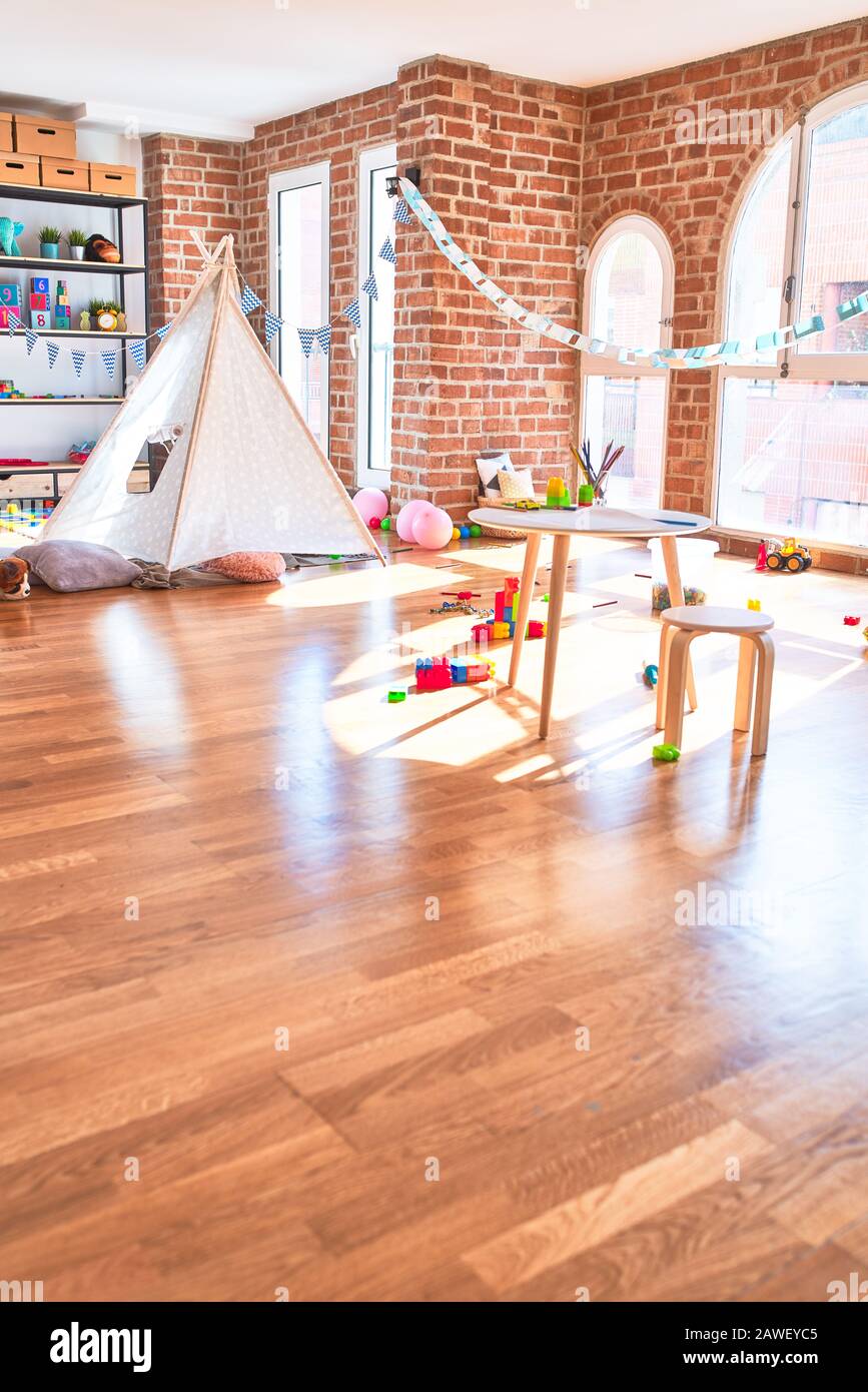 Picture of preschool playroom with colorful furniture and toys around ...