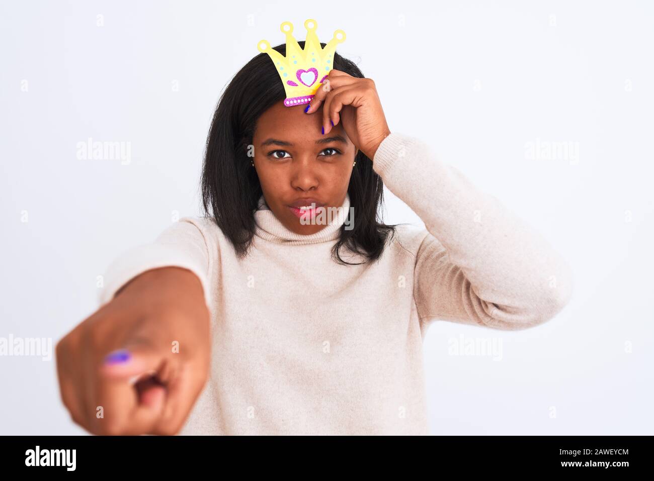Young african american woman wearing pretend queen crown over isolated ...